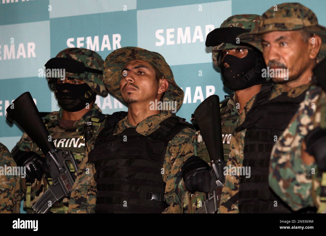 Two Men Wearing Bulletproof Vests And Camouflage Military Fatigues And