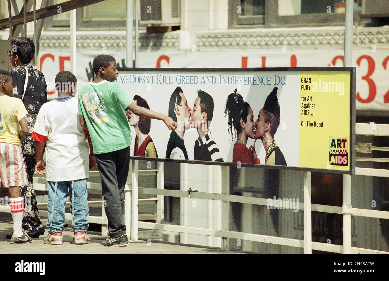 Two boys check out an AIDS awareness poster installed on a transit ...