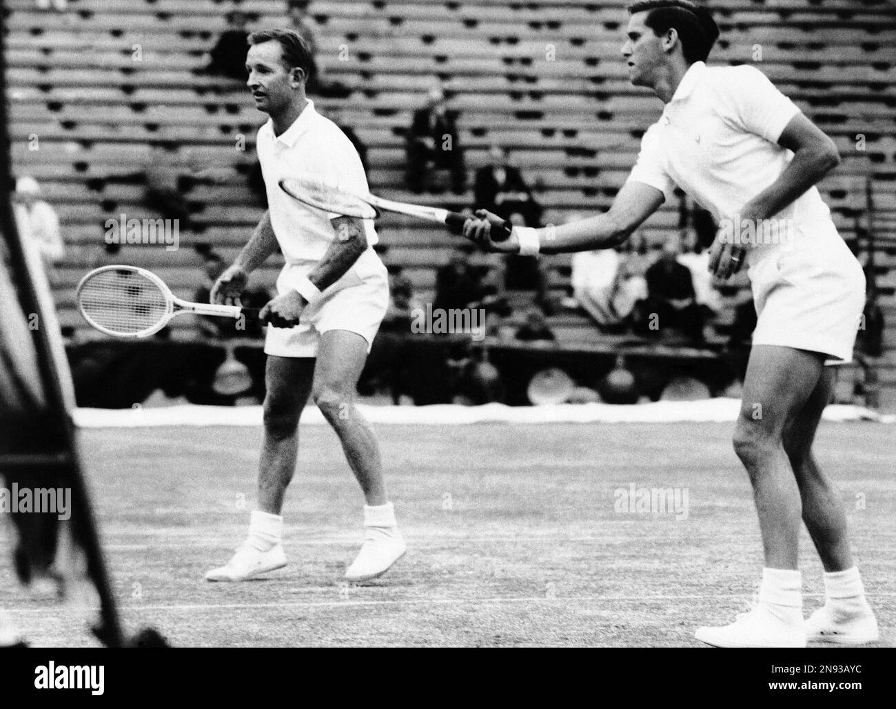 Rod Laver, left, and Roy Emerson move to the net in a double-barrel ...