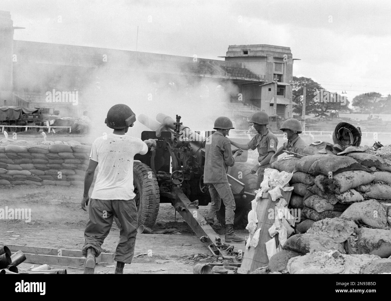 Vietnamese soldiers firing a canon during the Vietnam War. Location and ...