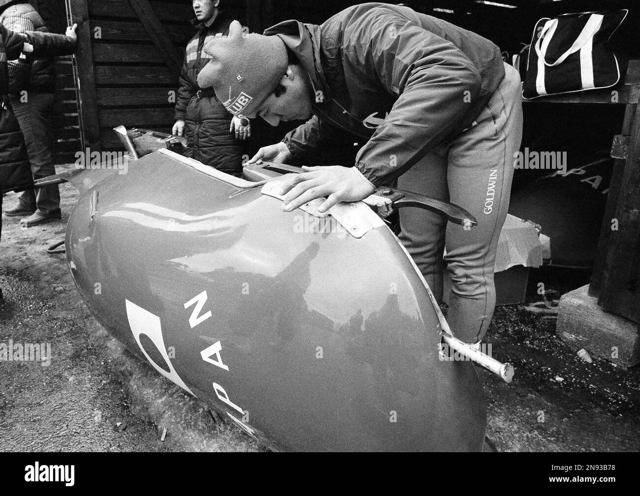 Coach Shozo Suzuki of the Japanese Olympic Bobsled team looks a sled ...