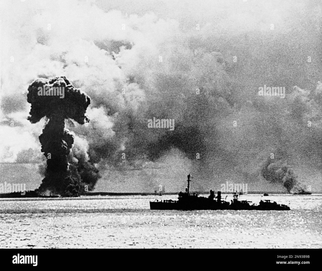 A United States destroyer patrols a scene of destruction at Port Darwin ...