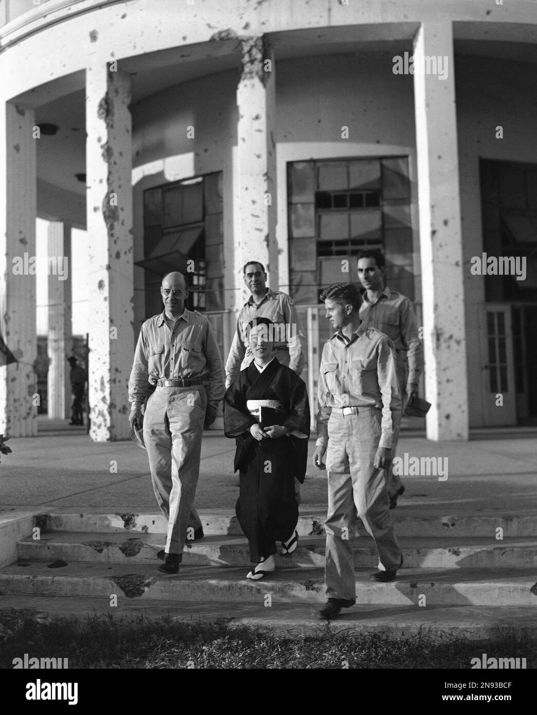 Surrounded by members of her husband's defense staff, Fujiko Homma ...