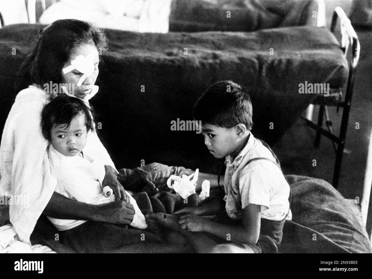 Members of a Filipino family all injured in the same bomb raid, sit on ...