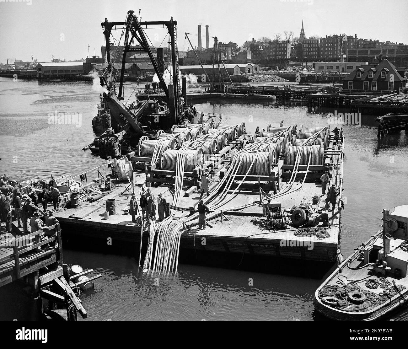 A total of 18 submarine telephone cables unreeled from a scow across ...