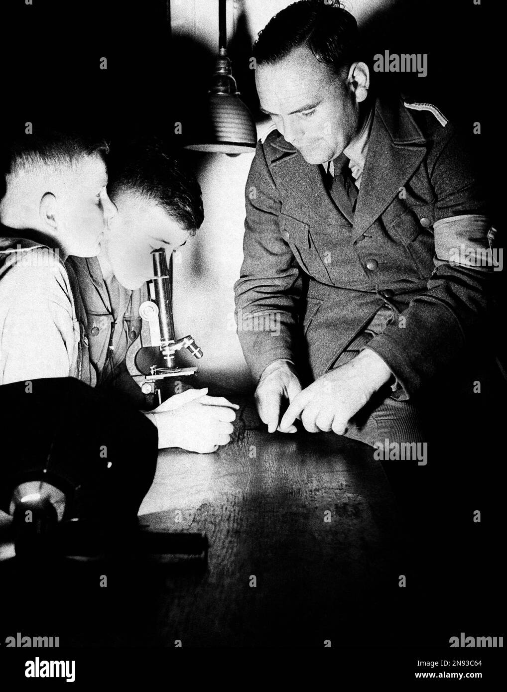An unidentified Nazi officer gives a biological lesson to students ...