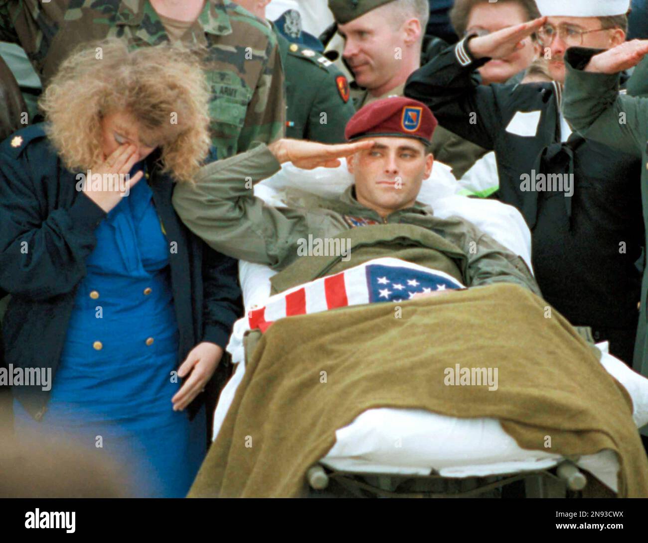 Staff Sgt. Daniel Stamaris of Boise, Idaho, salutes during the playing ...