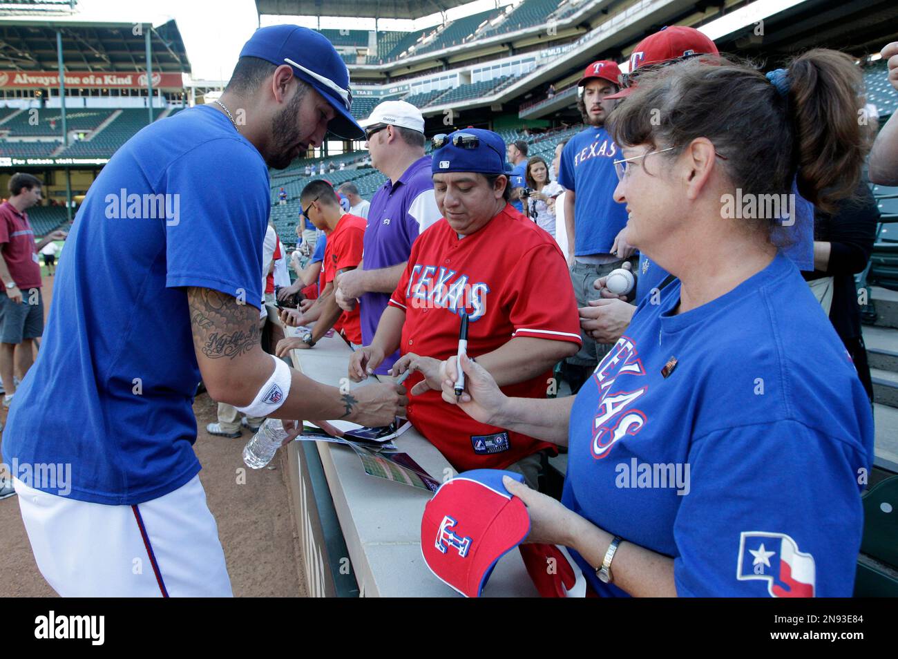 Texas Rangers' Mike Adams signs autographs for fans following batting ...