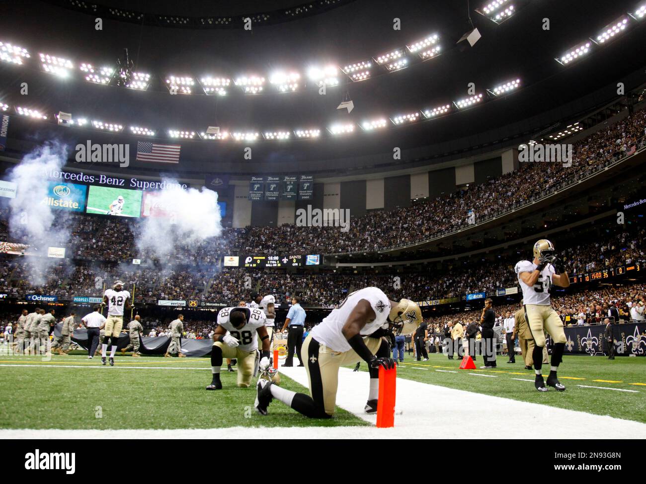 New Orleans Saints players kneel in prayer before an NFL football game ...