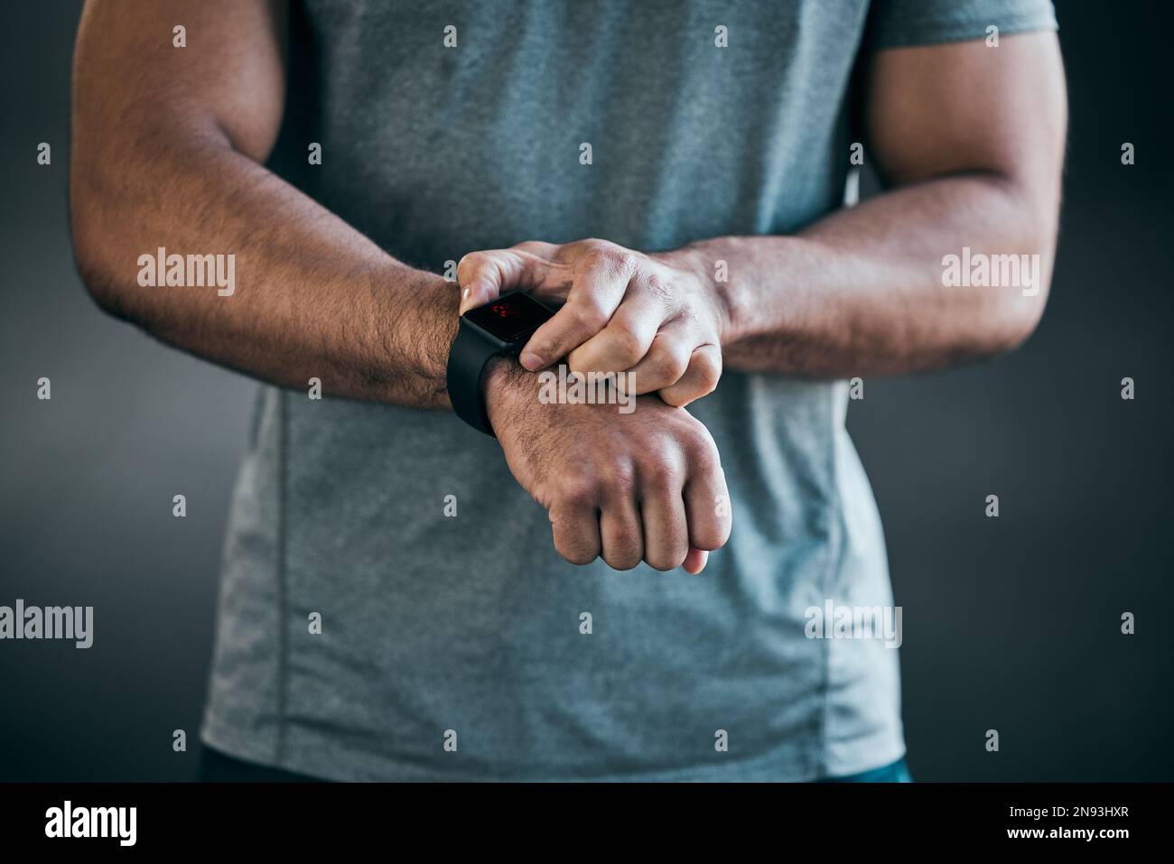 Start the timer. an unrecognizable young male athlete checking his ...
