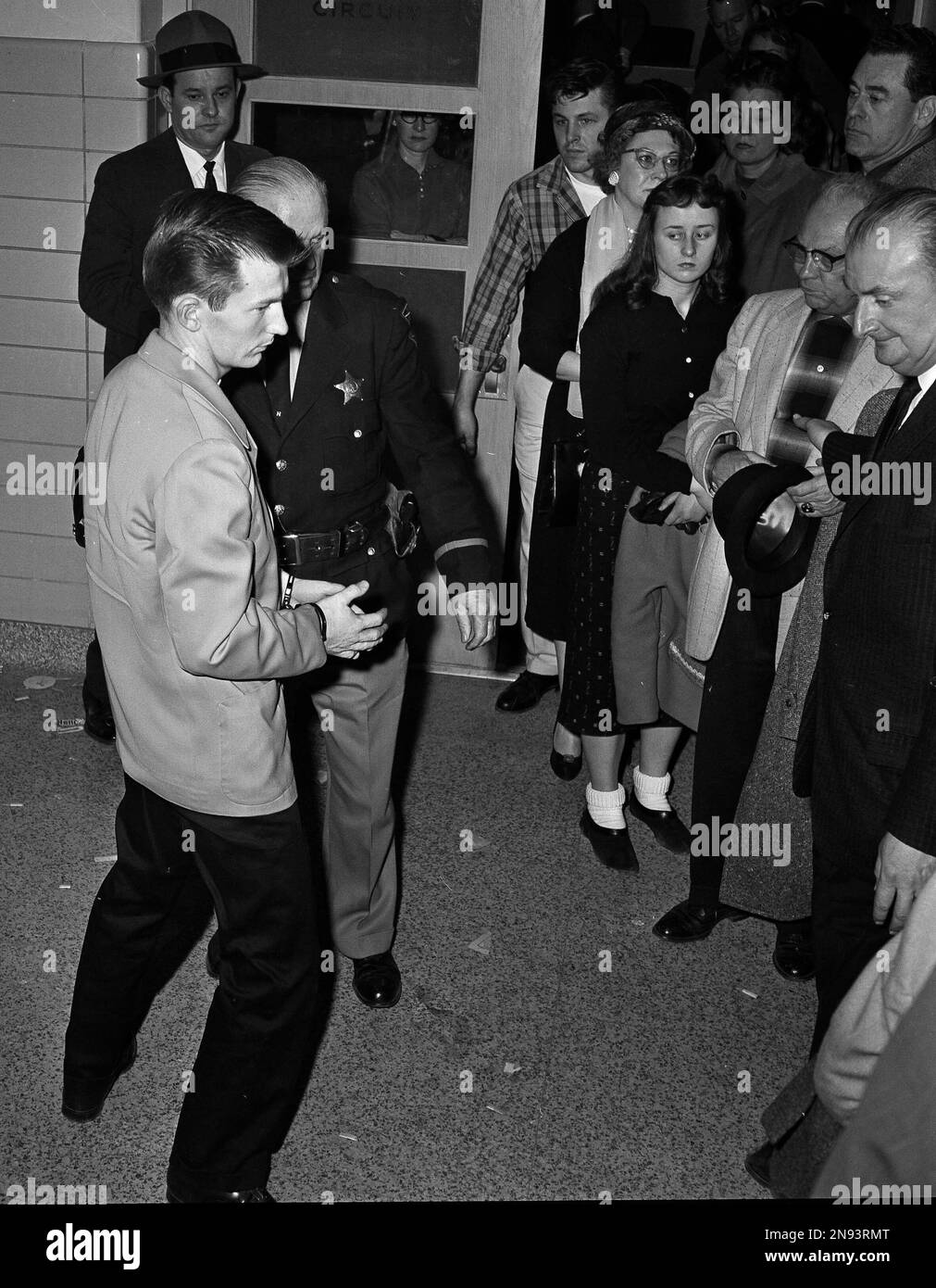 Spectators have a close up look at Chester Weger, in handcuffs, who is ...