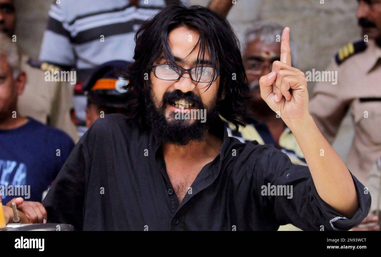 Indian political cartoonist Aseem Trivedi gestures after he is arrested ...