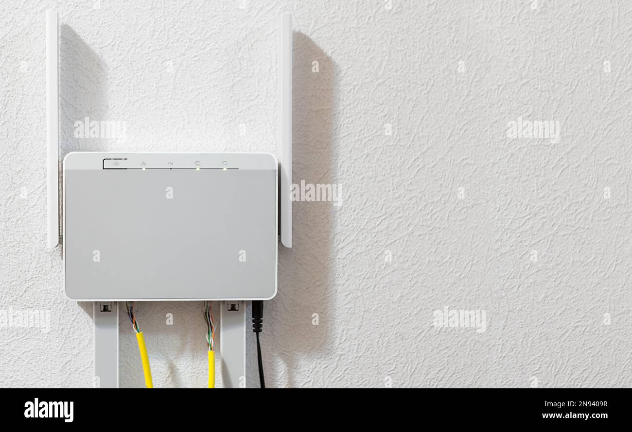 Dual-band home router attached to the wall, copyspace Stock Photo - Alamy