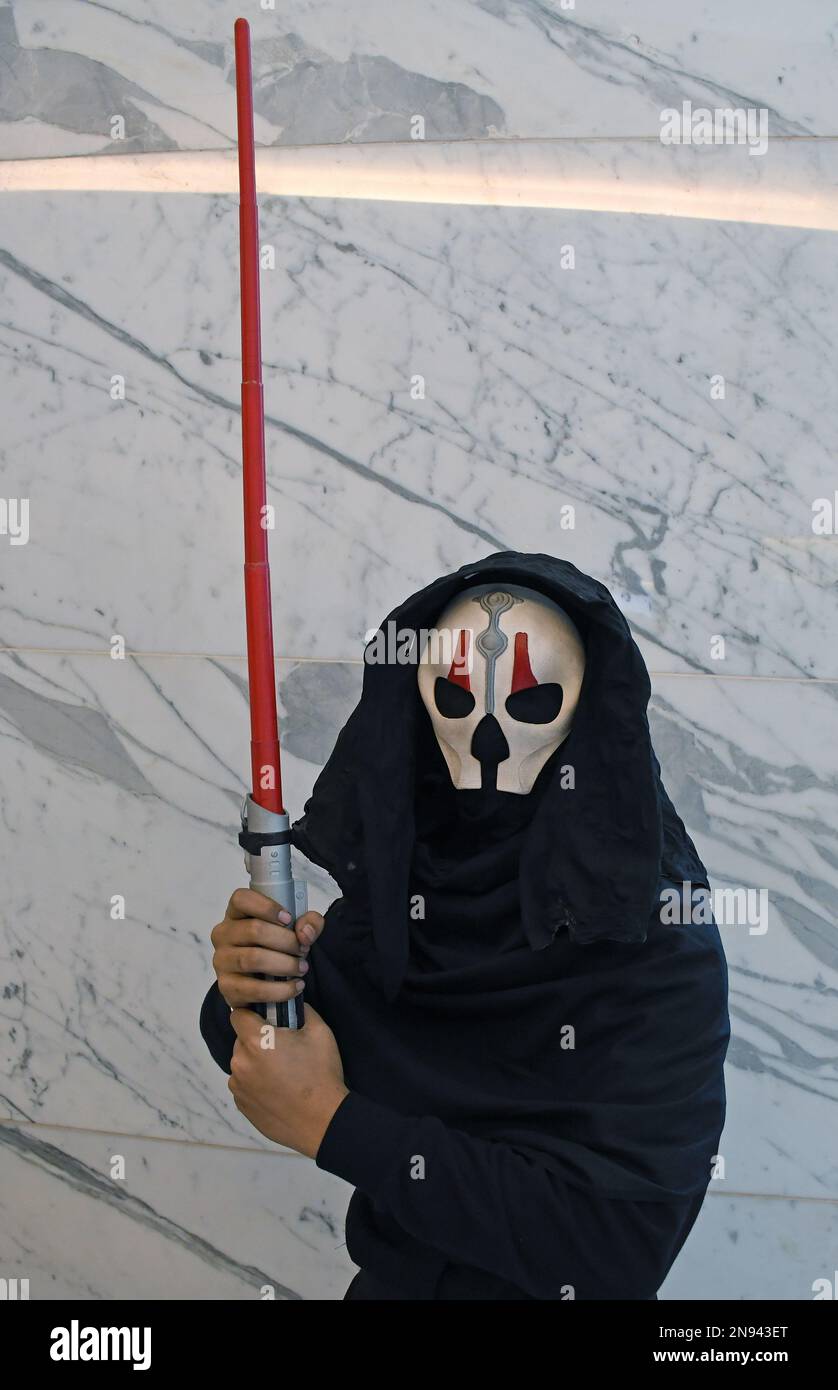 A cosplayer dressed as Darth Nihilus from Star wars poses for a photo ...