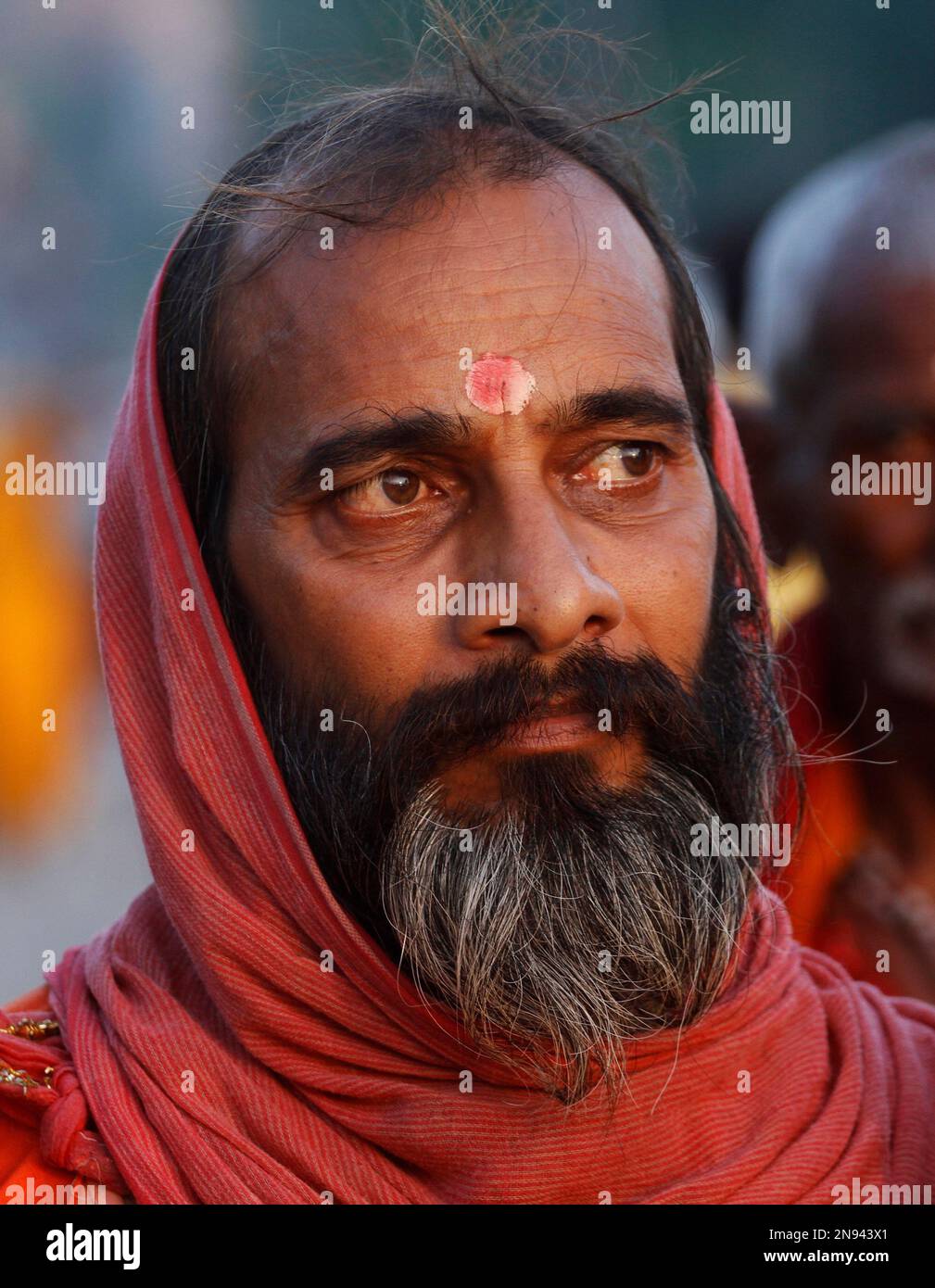 A Hindu holy man stands beside the Ganges River, in Allahabad, India ...