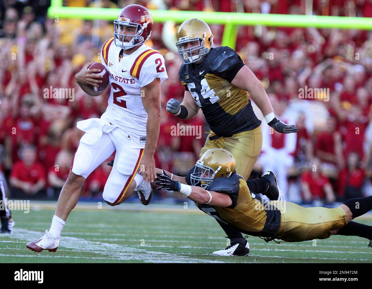 Iowa State quarterback Steele Jantz runs away from Iowa's Steve Bigach ...