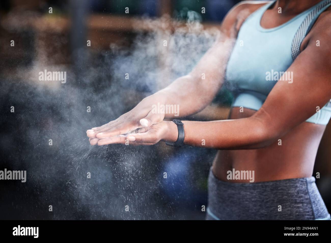 Im about to do some heavy lifting. a sporty young woman dusting her ...
