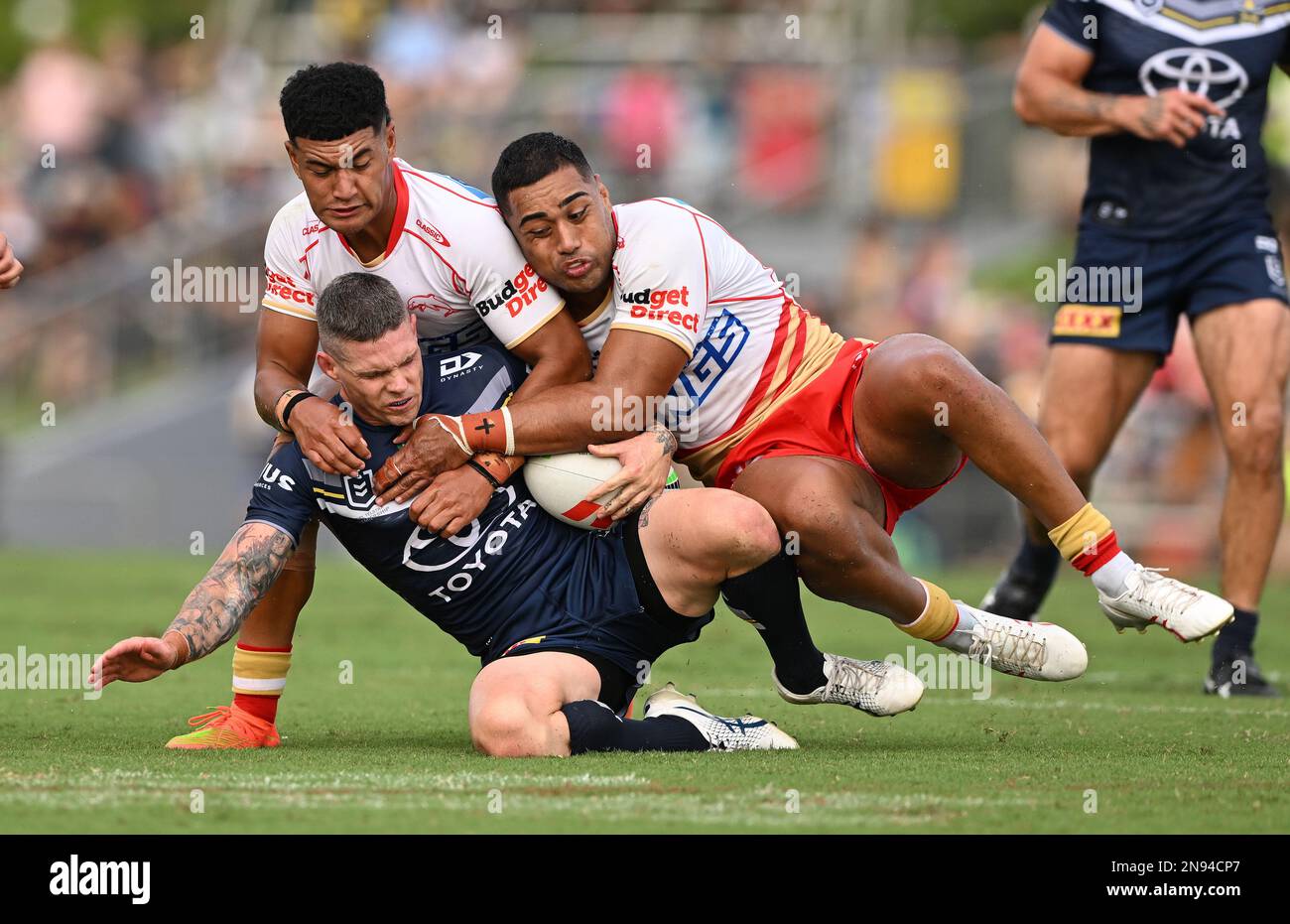 Ben Hampton of the Cowboys is tackled by Isaiya Katoa (left ) and ...