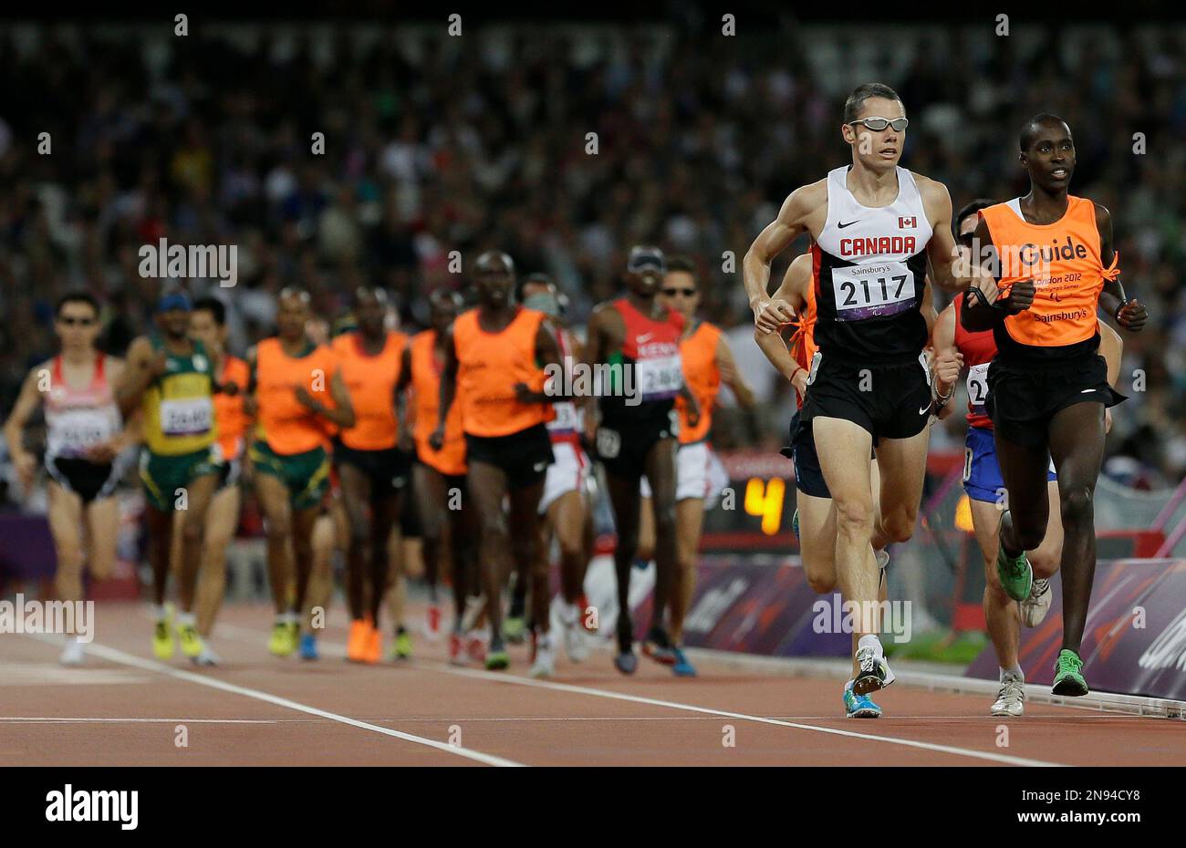 Canada's Jason Dunkerley, second right, and his guide Josh Karanja ...