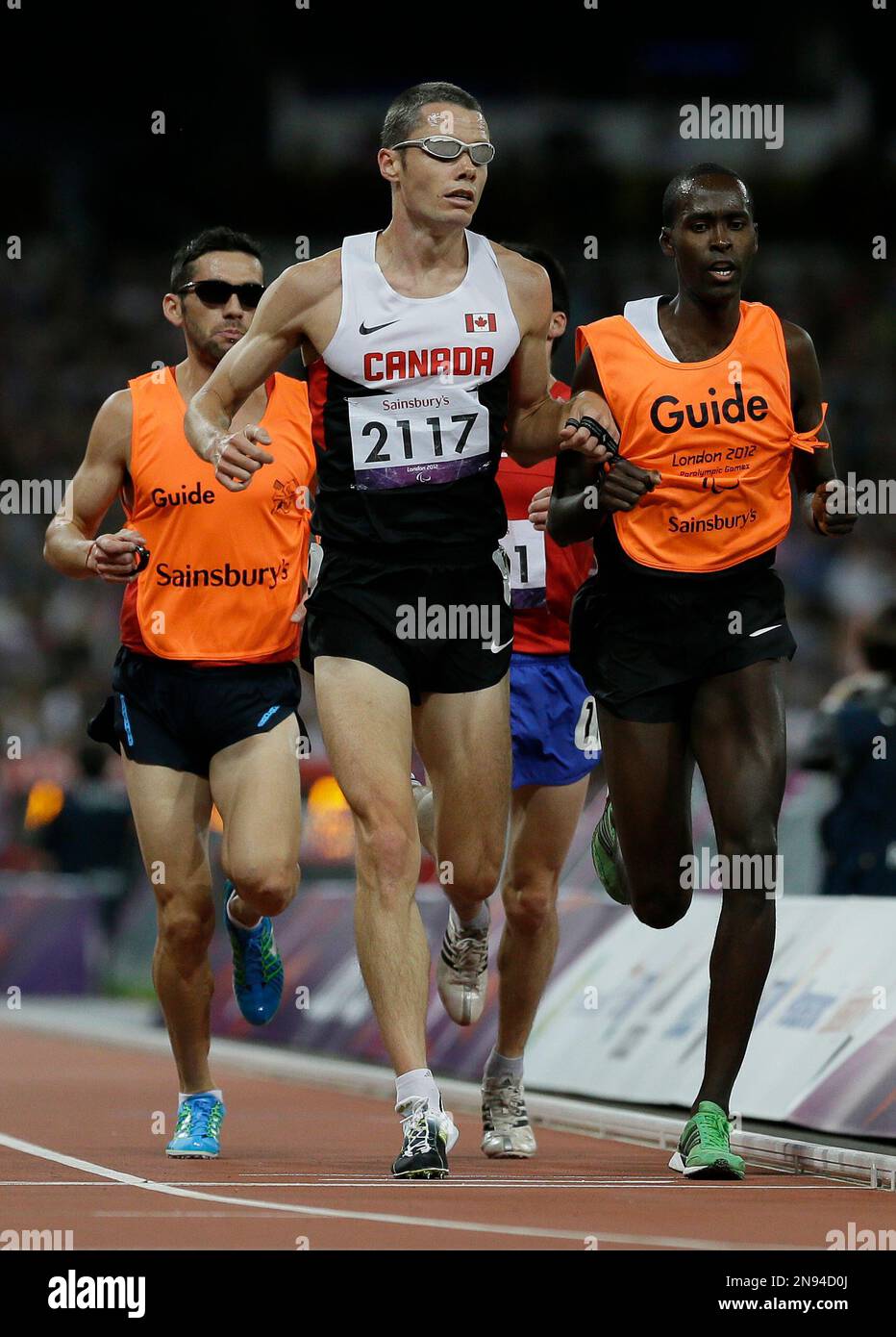 Canada's Jason Dunkerley and his guide Josh Karanja, right, compete in ...