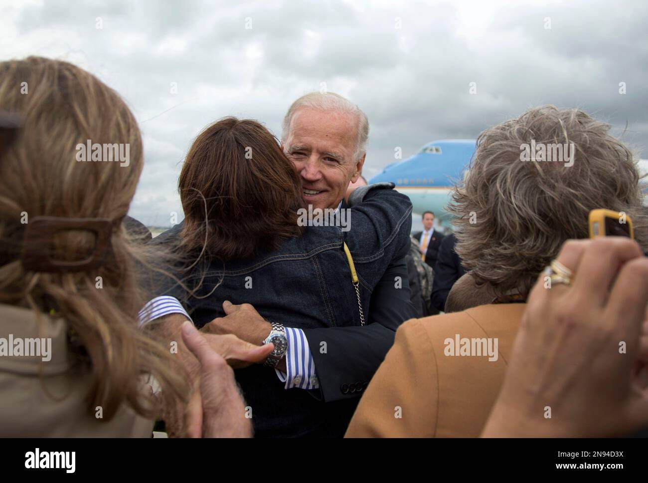 Vice President Joe Biden hugs a supporter on the tarmac as he arrives ...