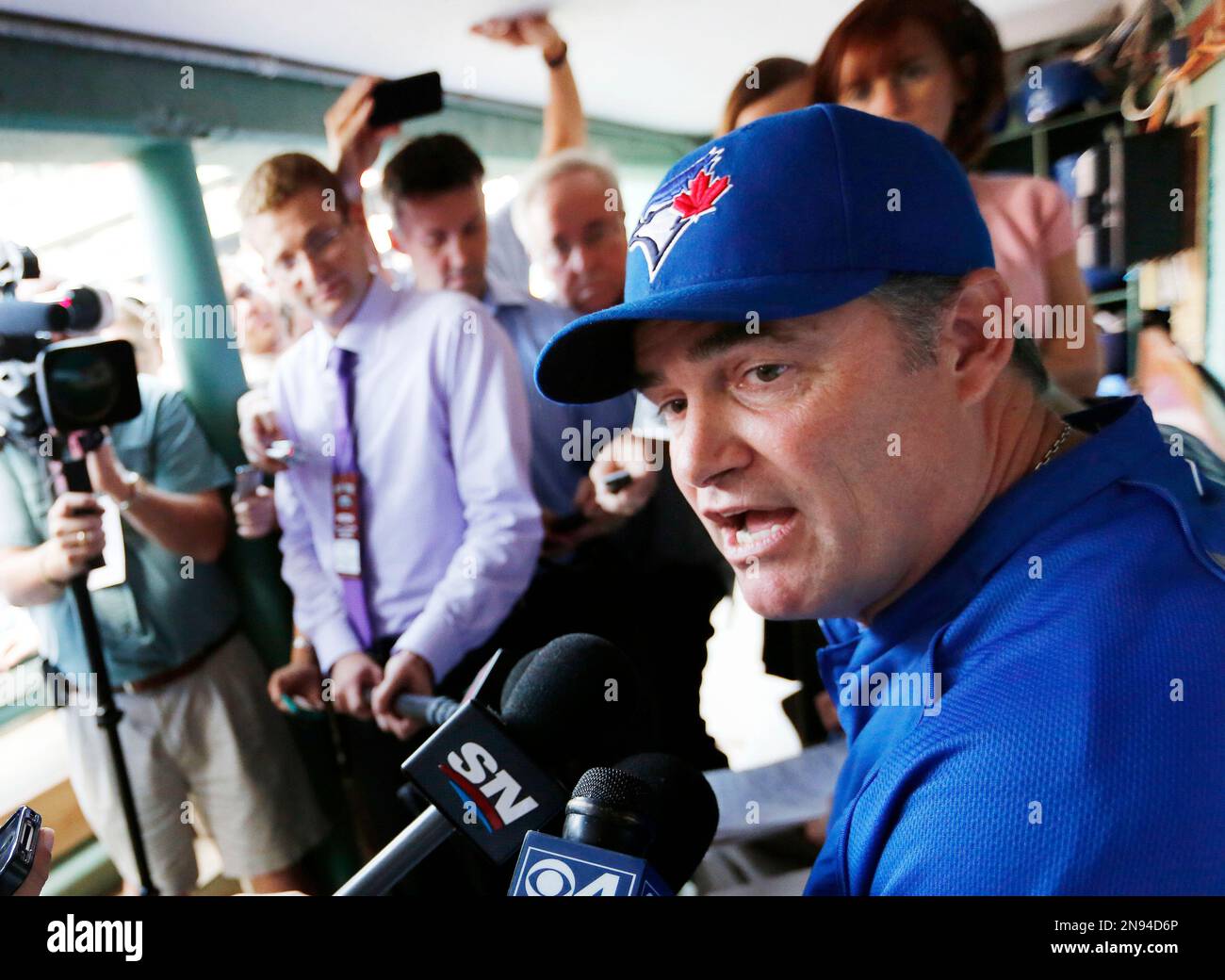 Toronto Blue Jays manager John Farrell, right, talks with reporters ...