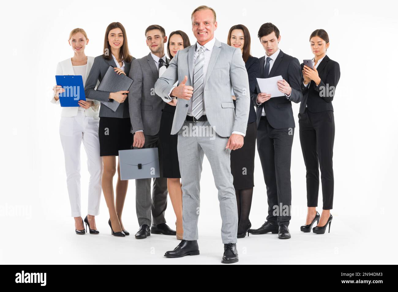 Business man leading a successful corporate group with thumbs up ...