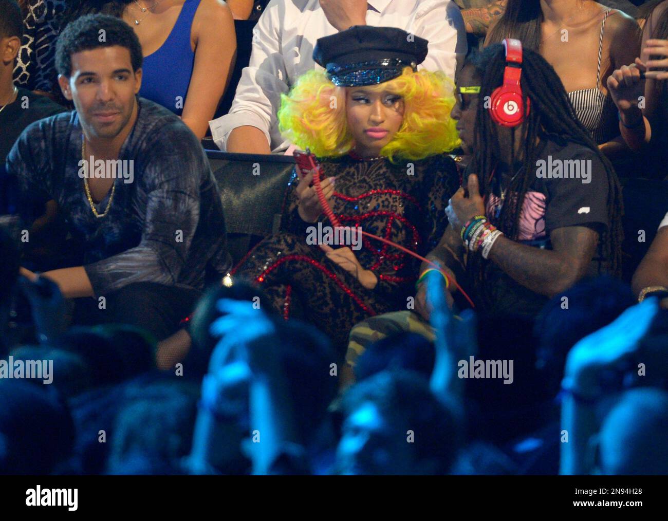 From left, Drake, Nicki Minaj and Lil Wayne are seen in the audience at ...