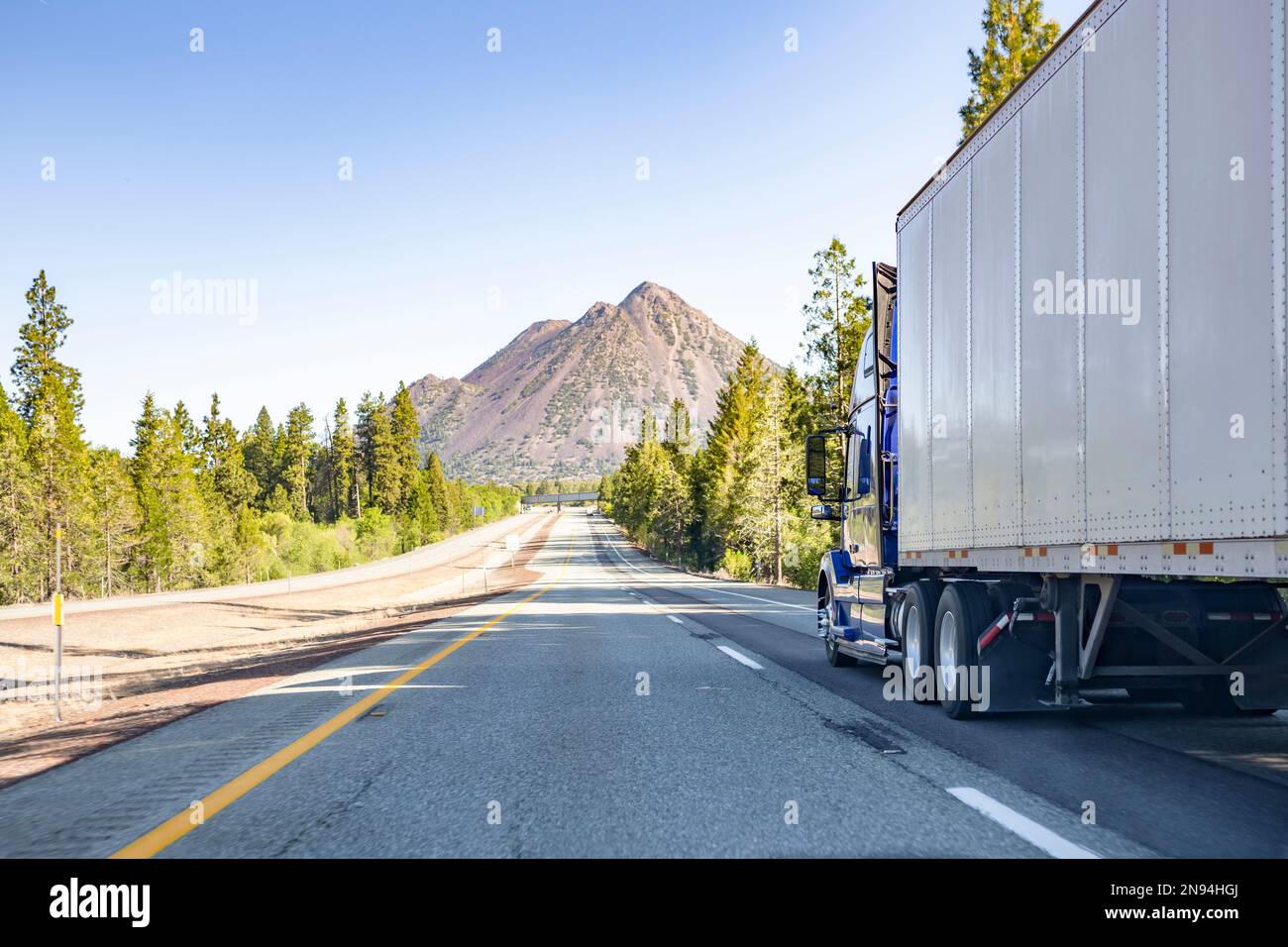 Industrial long hauler big rig blue semi truck tractor with high cab ...