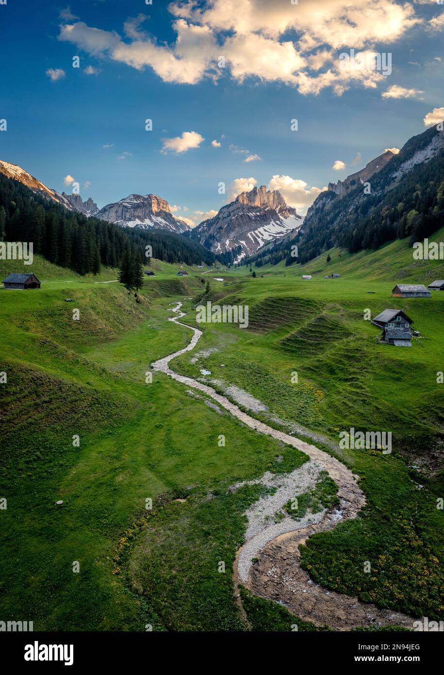 Aerial view of a valley, houses standing on a meadow hiking trails and ...