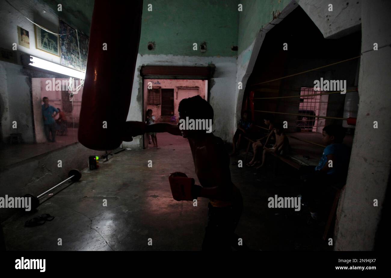 A young boy punches a sand bag hanging inside the Promises From My ...