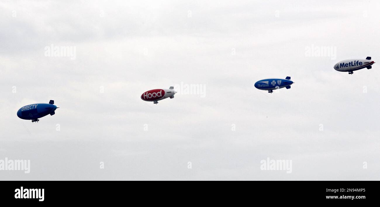 Four advertising blimps, DirecTV, Hood, Horizon, and MetLife, fly ...