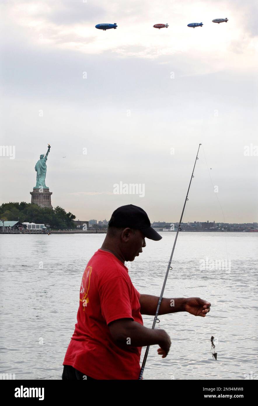 As Four advertising blimps, DirecTV, Hood, Horizon, and MetLife, fly ...