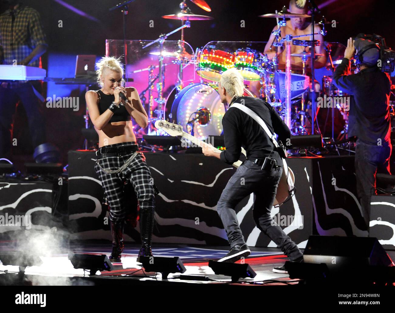 Gwen Stefani, left, performs with bassist Tony Kanal and drummer Adrian ...