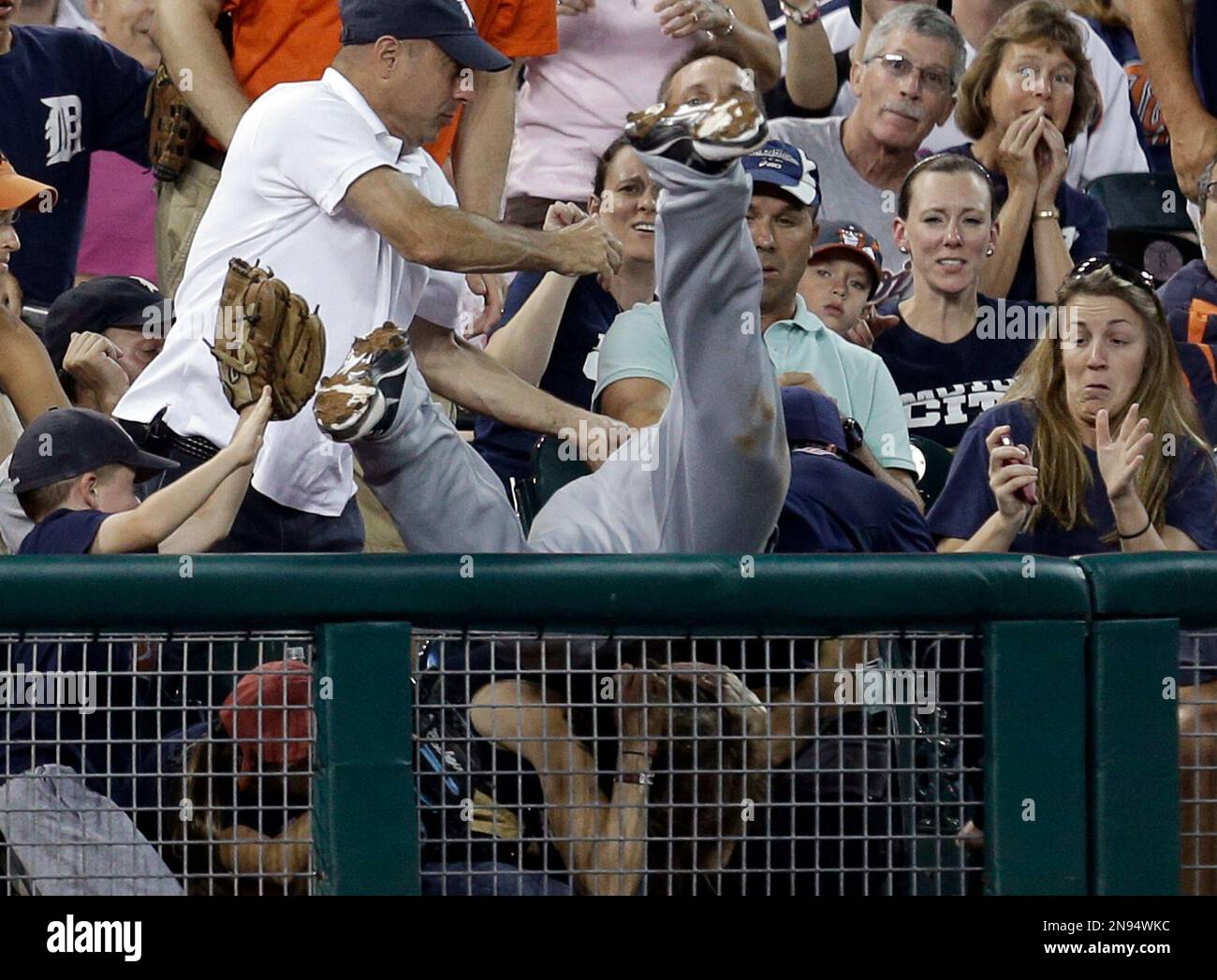 Cleveland Indians third baseman Jason Donald falls into the stands ...