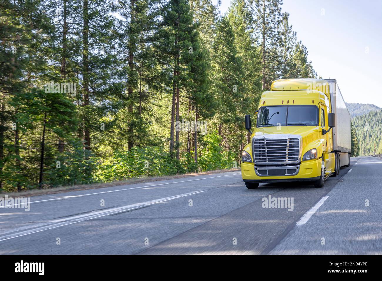 Industrial long hauler big rig yellow semi truck tractor with ...
