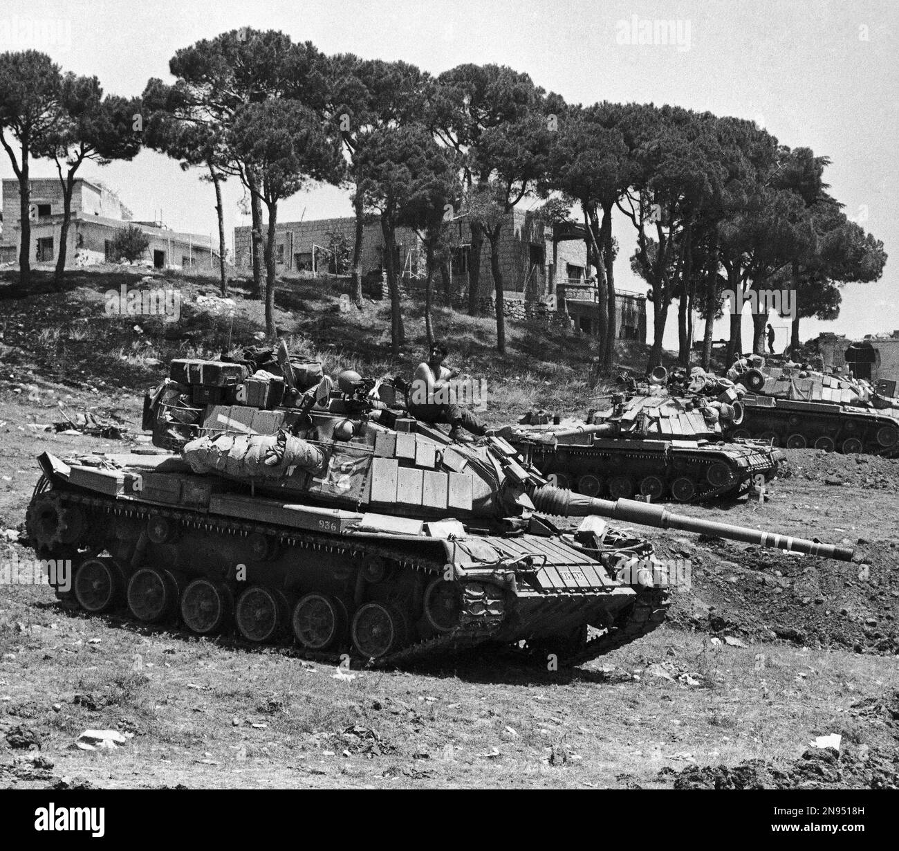 Israeli tanks are in position under some cedar trees, the national tree ...