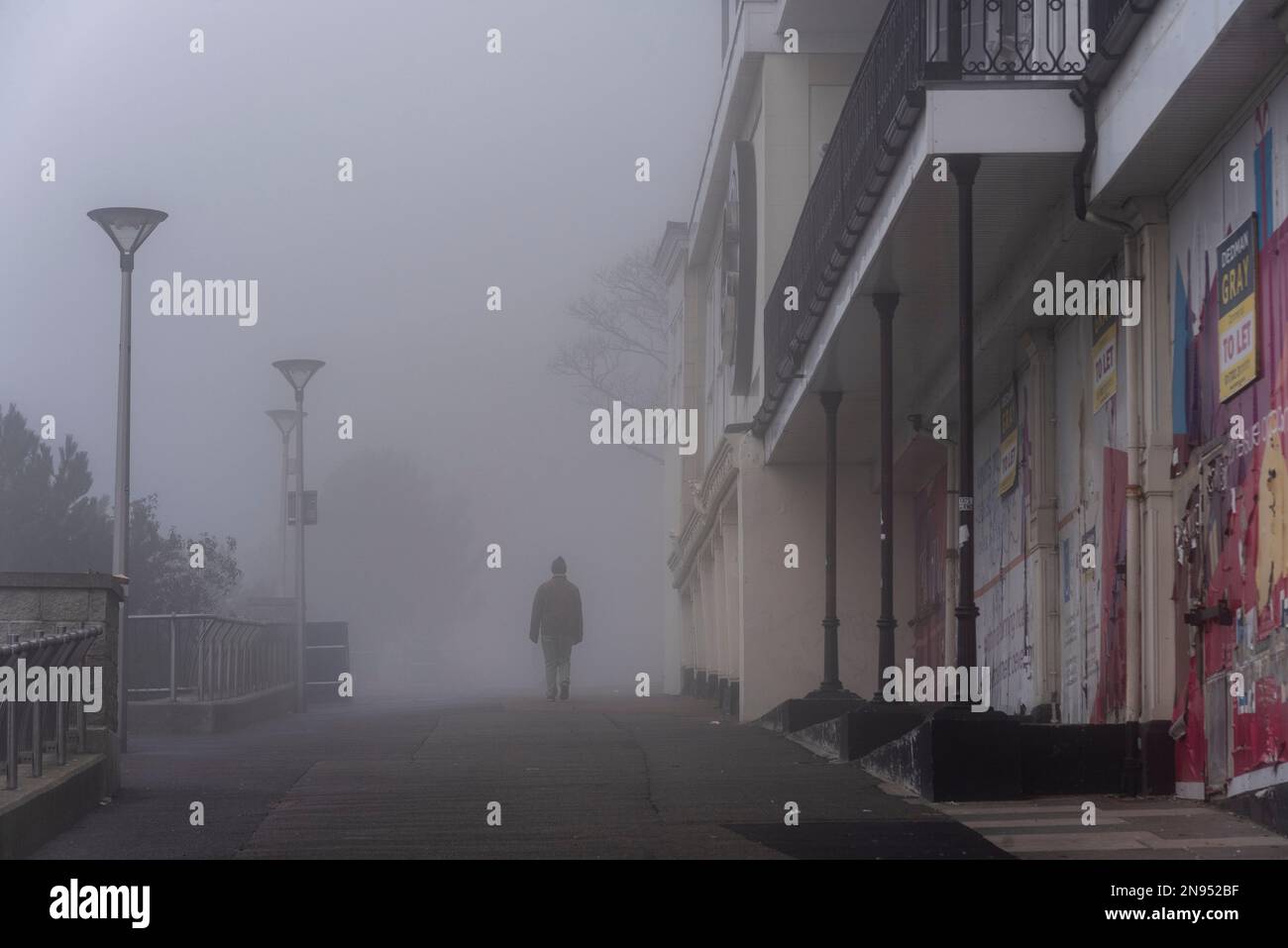 A lone male walking up Pier Hill disappearing into the fog. Foggy day ...