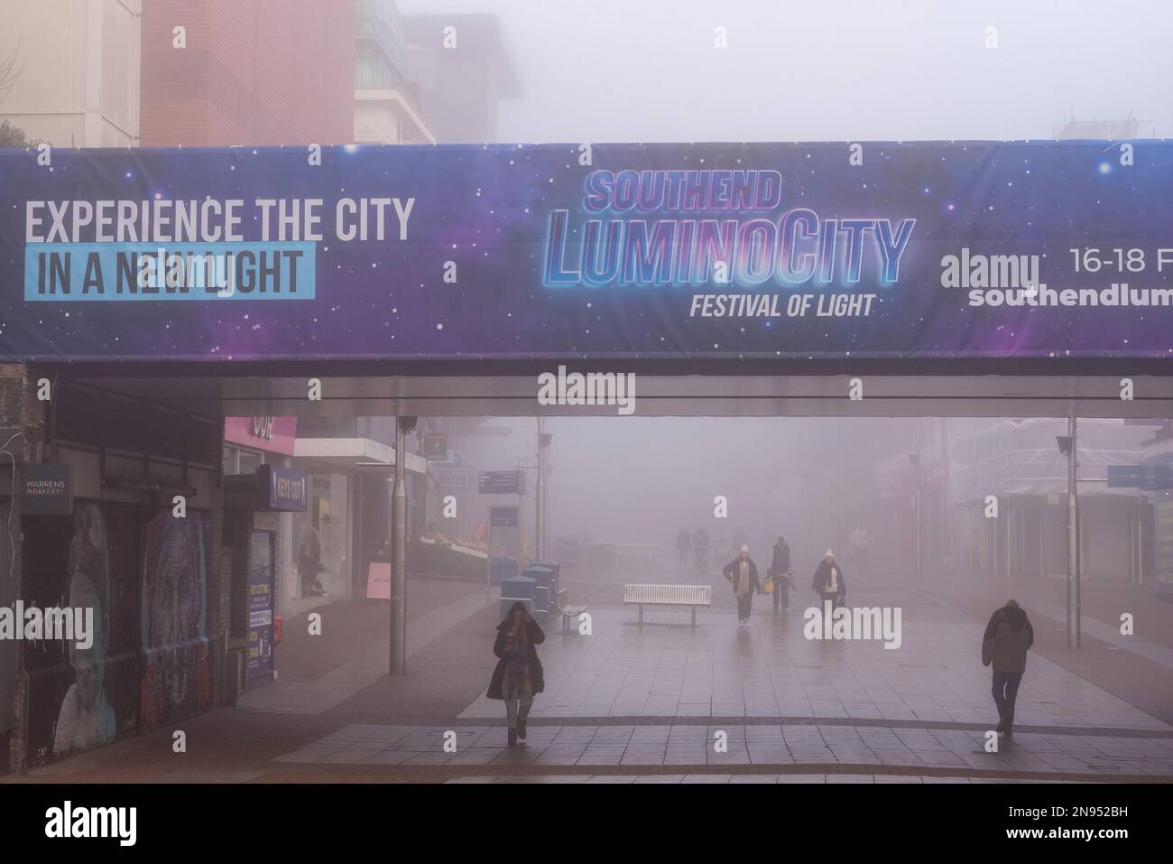 People are walking the High Street in fog under advertising for the ...