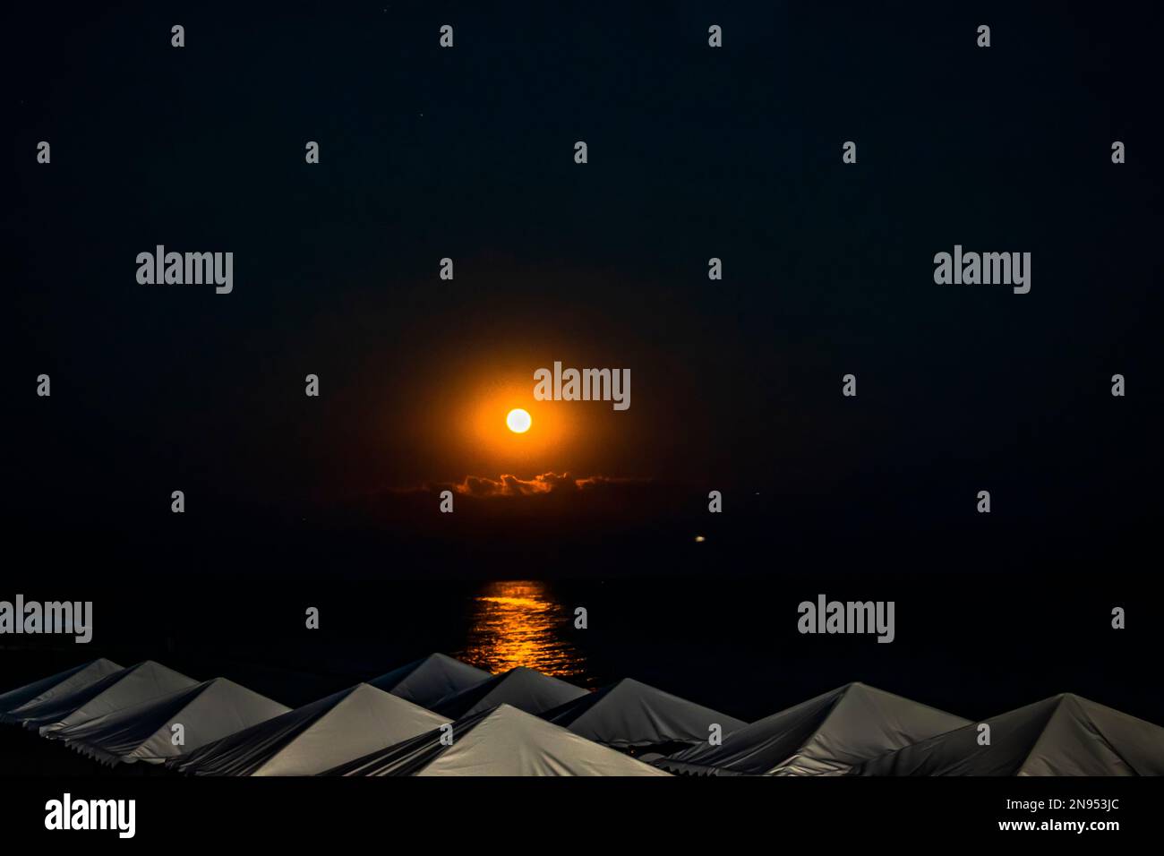 The fool moon over the sea and the moonpath Stock Photo - Alamy