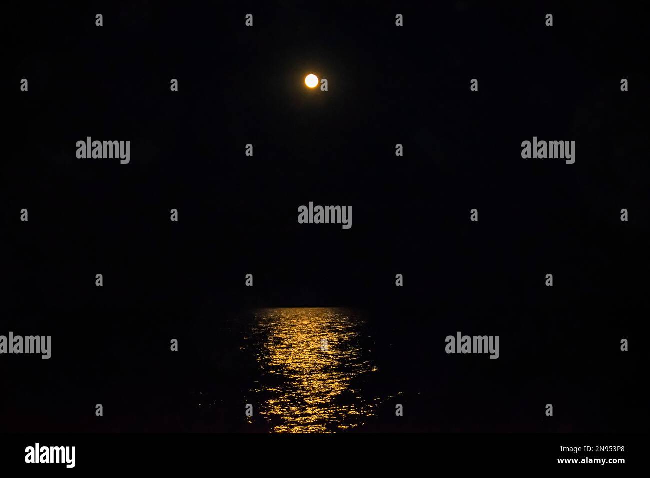 The fool moon over the sea and the moonpath Stock Photo - Alamy