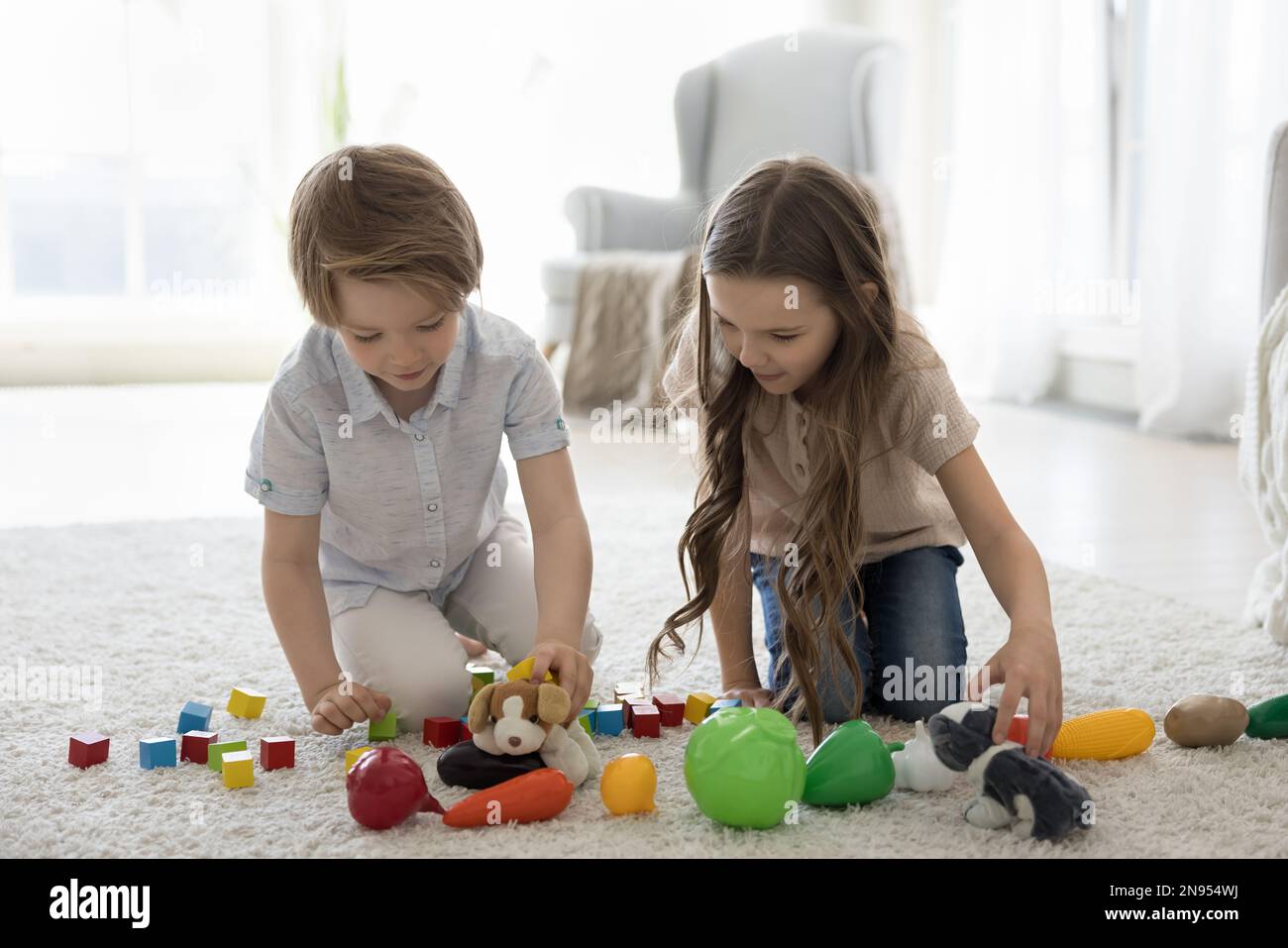 Two cute little brother and sister kids playing with toys Stock Photo ...