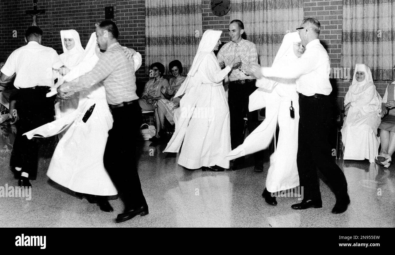 Employees of St. Mary's Hospital and nuns join in a square dance during ...