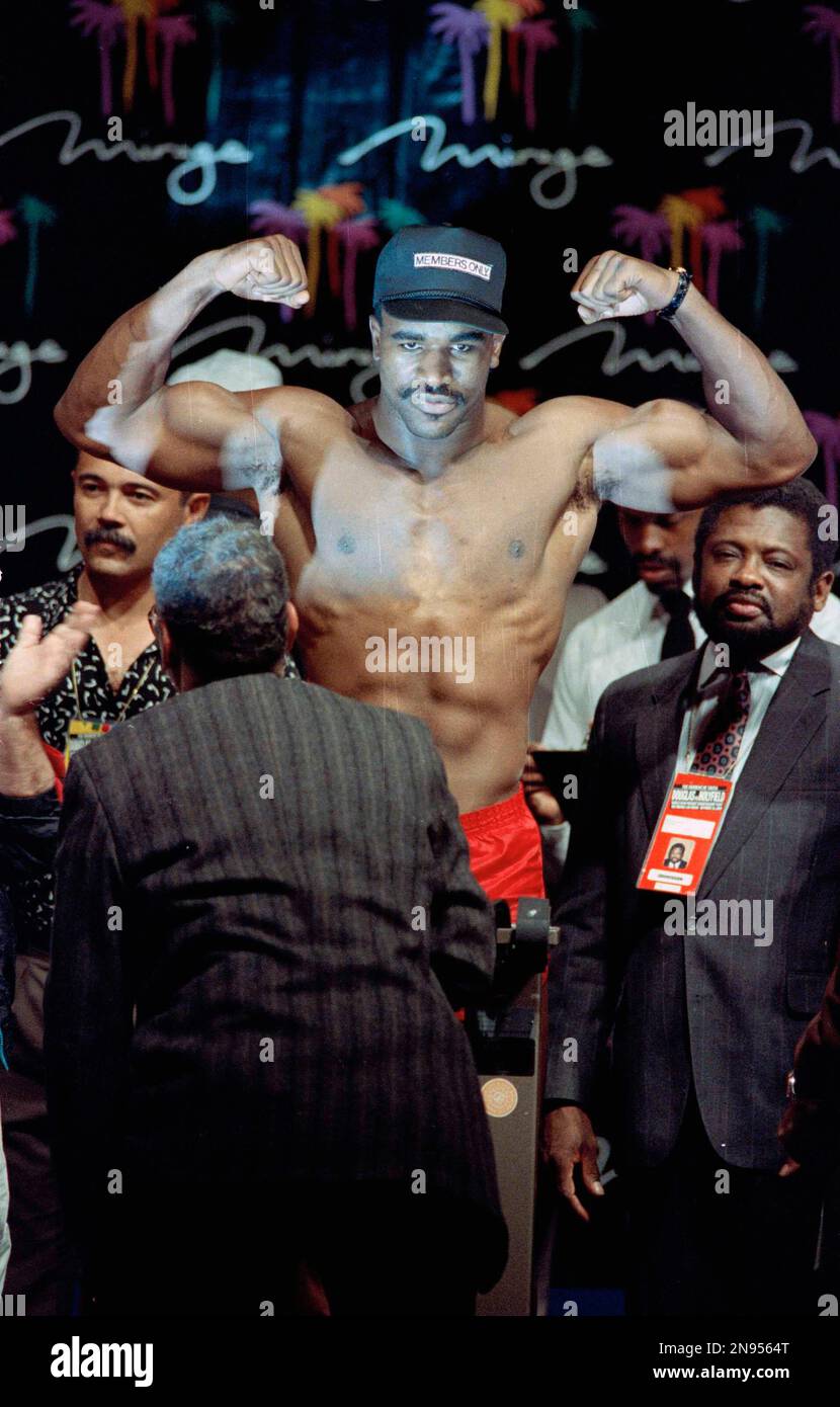 Heavyweight boxer Evander Holyfield flexes his muscles during weigh-in in Las Vegas, Oct. 24 ...