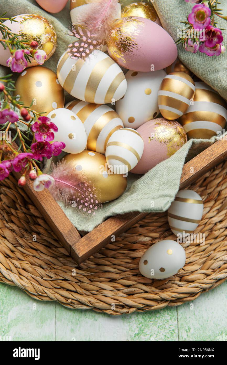 Easter decor. Colored Easter eggs in a wooden box on the table. The ...