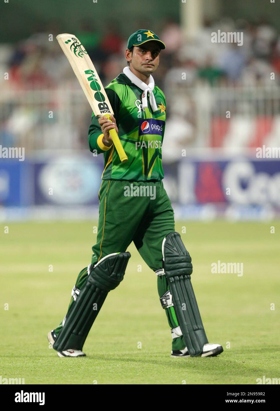 Pakistan's Muhammad Hafeez raises his bat to the crowd as walks off the ...