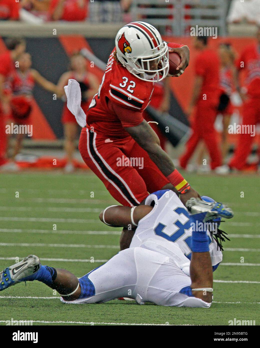 Louisville running back Senorise Perry (32) is stopped by Kentucky ...