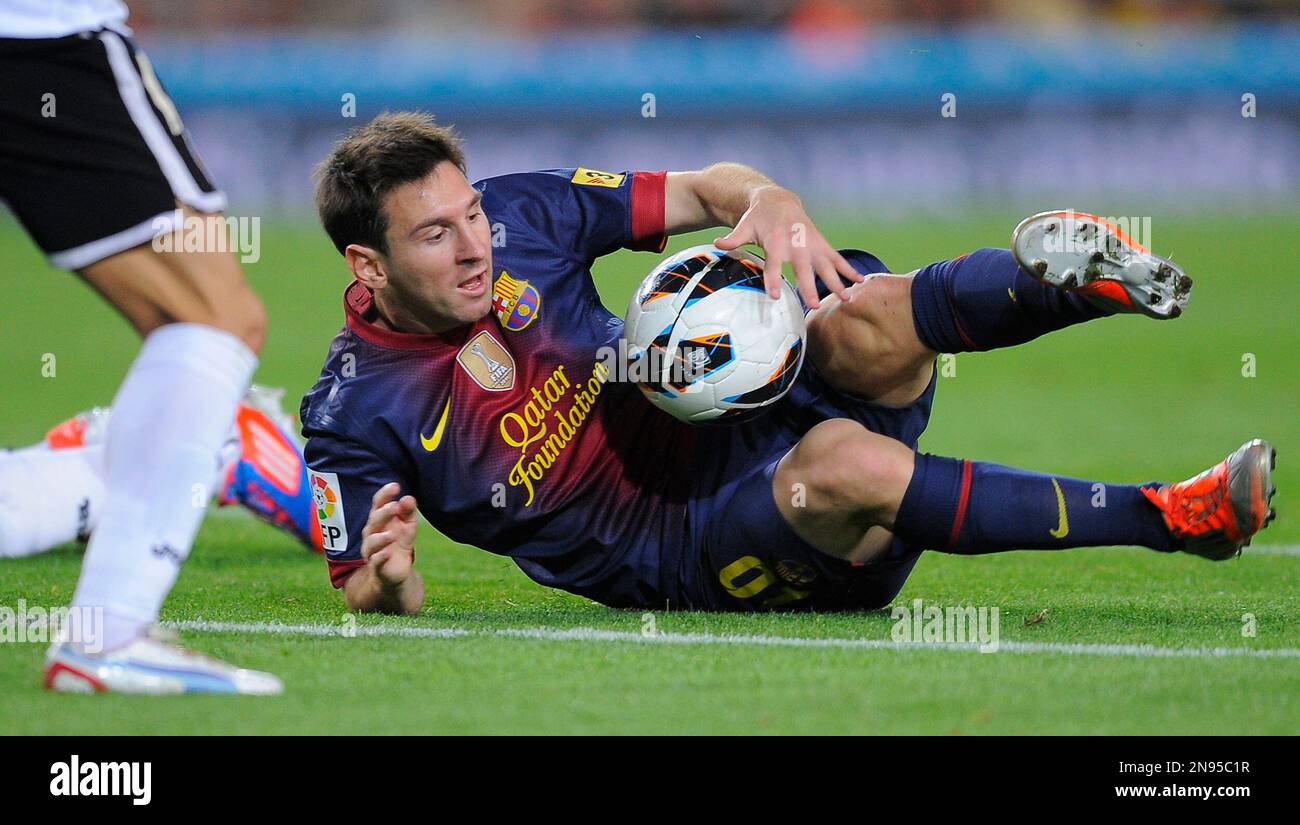 FC Barcelona's Lionel Messi from Argentina, falls in the pitch during a ...