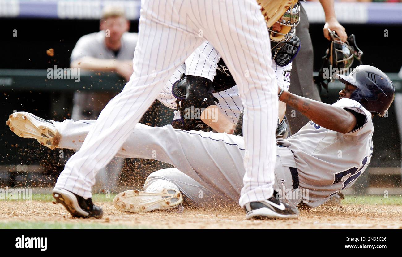 San Diego Padres' Cameron Maybin (24) is tagged out by Colorado Rockies ...