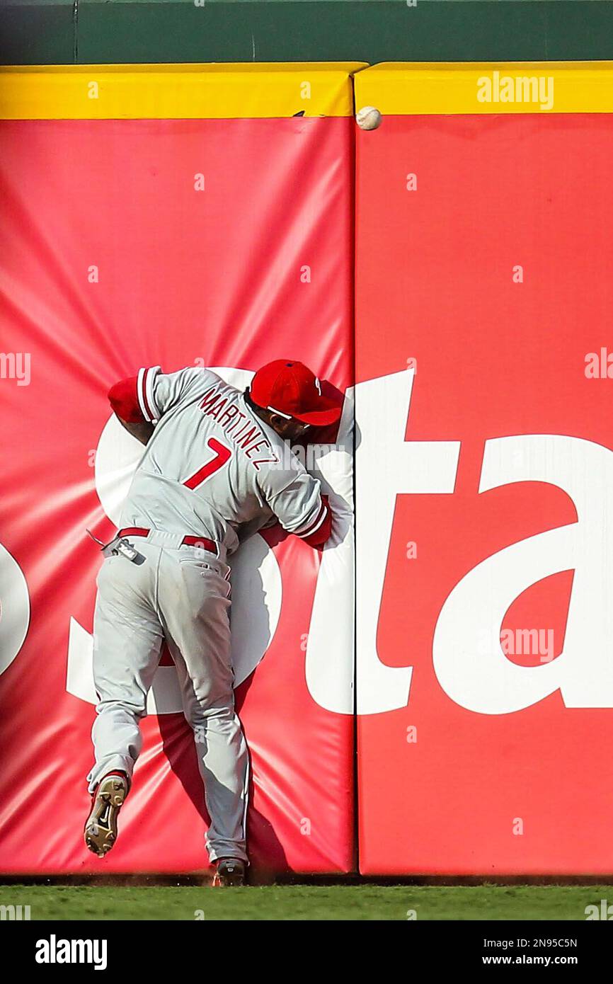 Philadelphia Phillies third baseman Michael Martinez (7) slams into the ...